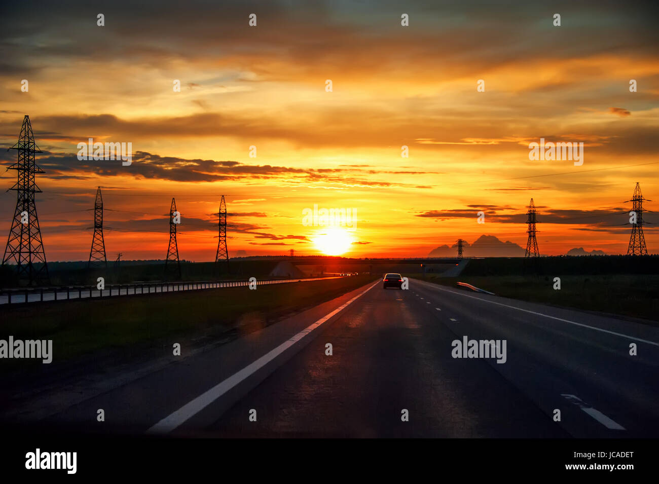 Highway with cars traveling on the sunset Stock Photo - Alamy