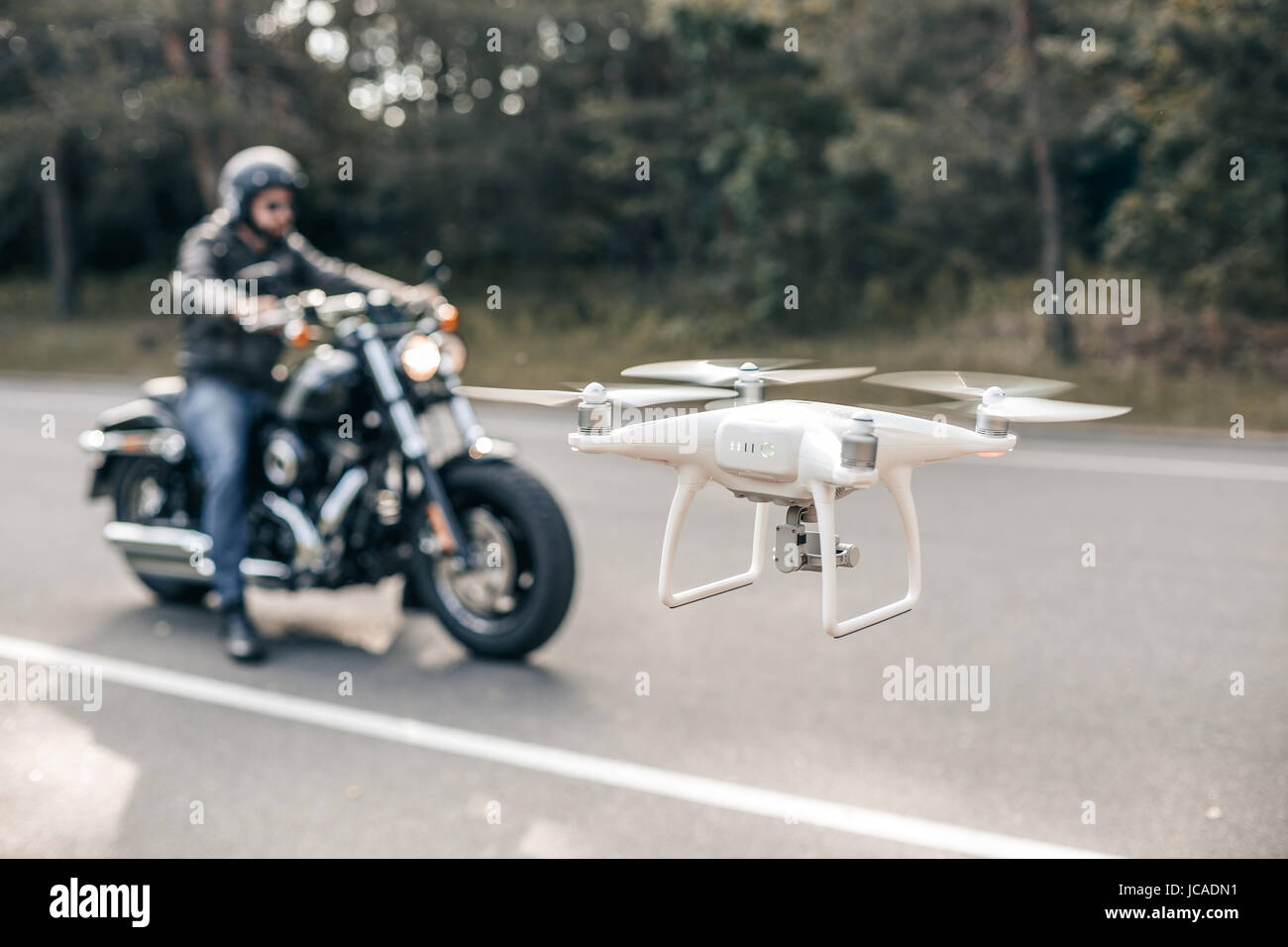Motorbike on the road riding and hovering drone Stock Photo - Alamy