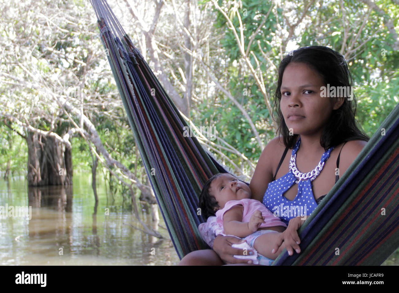 MANAUS, 10.06.2017: Young woman at the hammock with her baby in one of ...