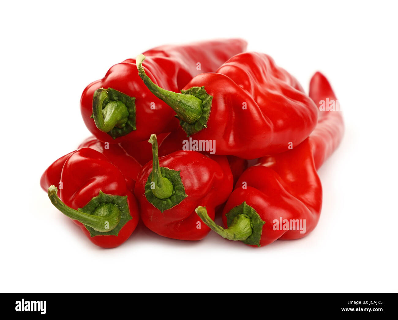 Group of several whole fresh red sweet paprika peppers isolated on ...