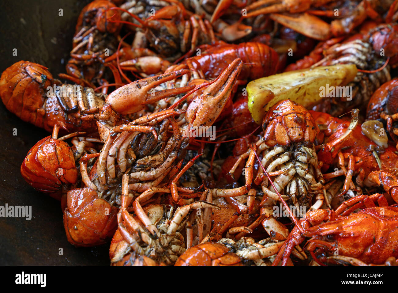 Portion of cooked ready to eat red crawfish (crayfish) with lemon in ...