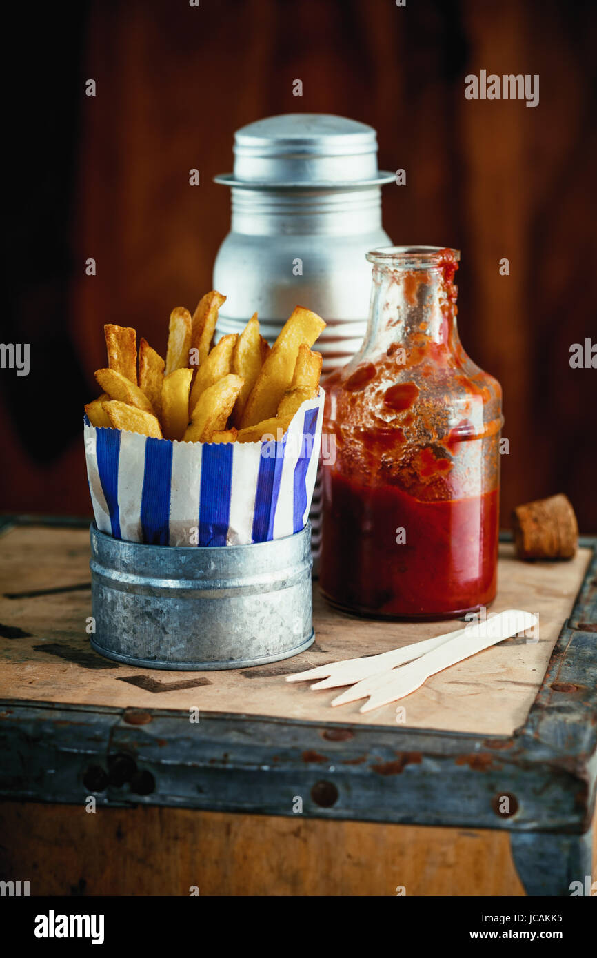 Colorful blue striped packet of crispy of French fries standing on a ...