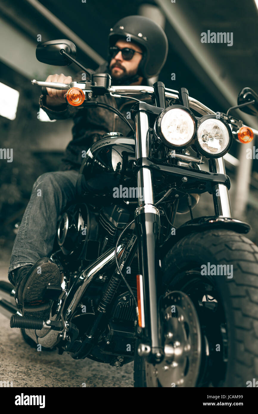 Biker in helmet and his style motorcycle on a city streets Stock Photo ...