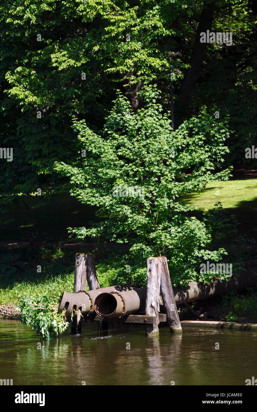 old canal pipes on River Stock Photo - Alamy