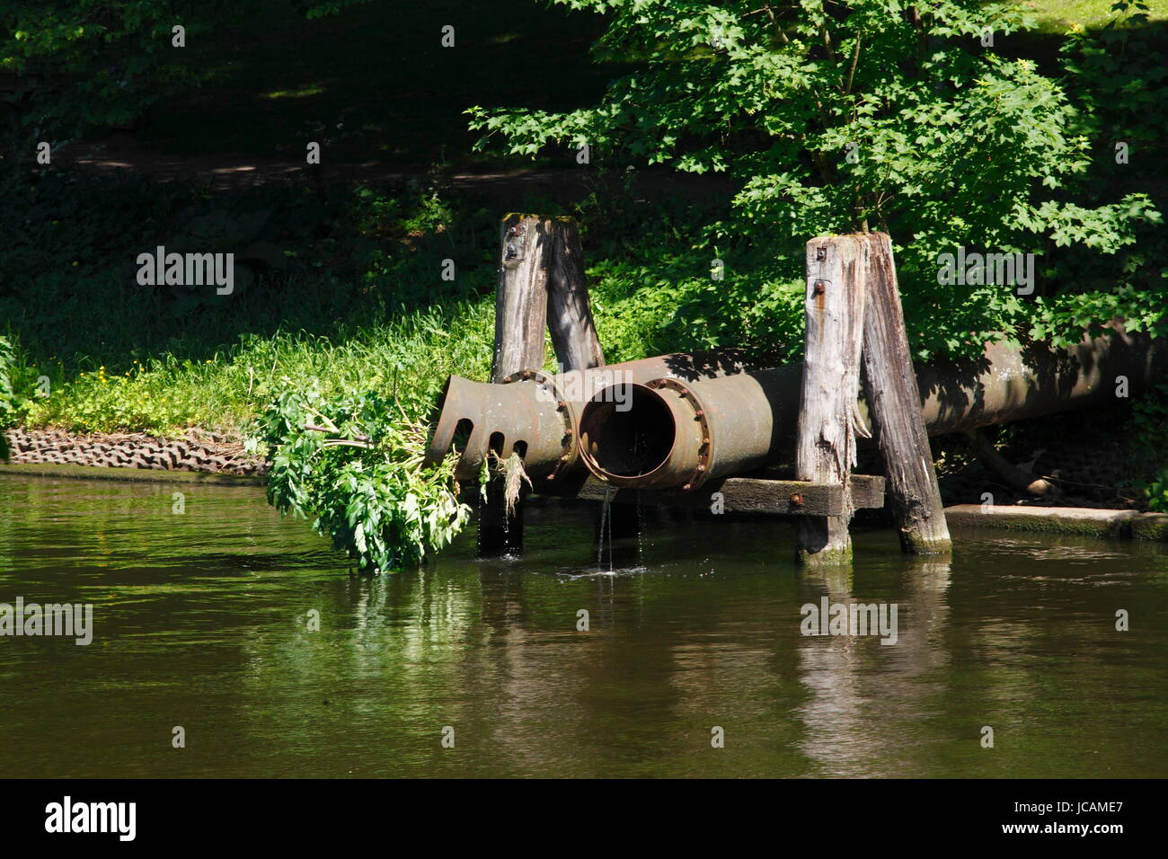 old canal pipes on River Stock Photo - Alamy