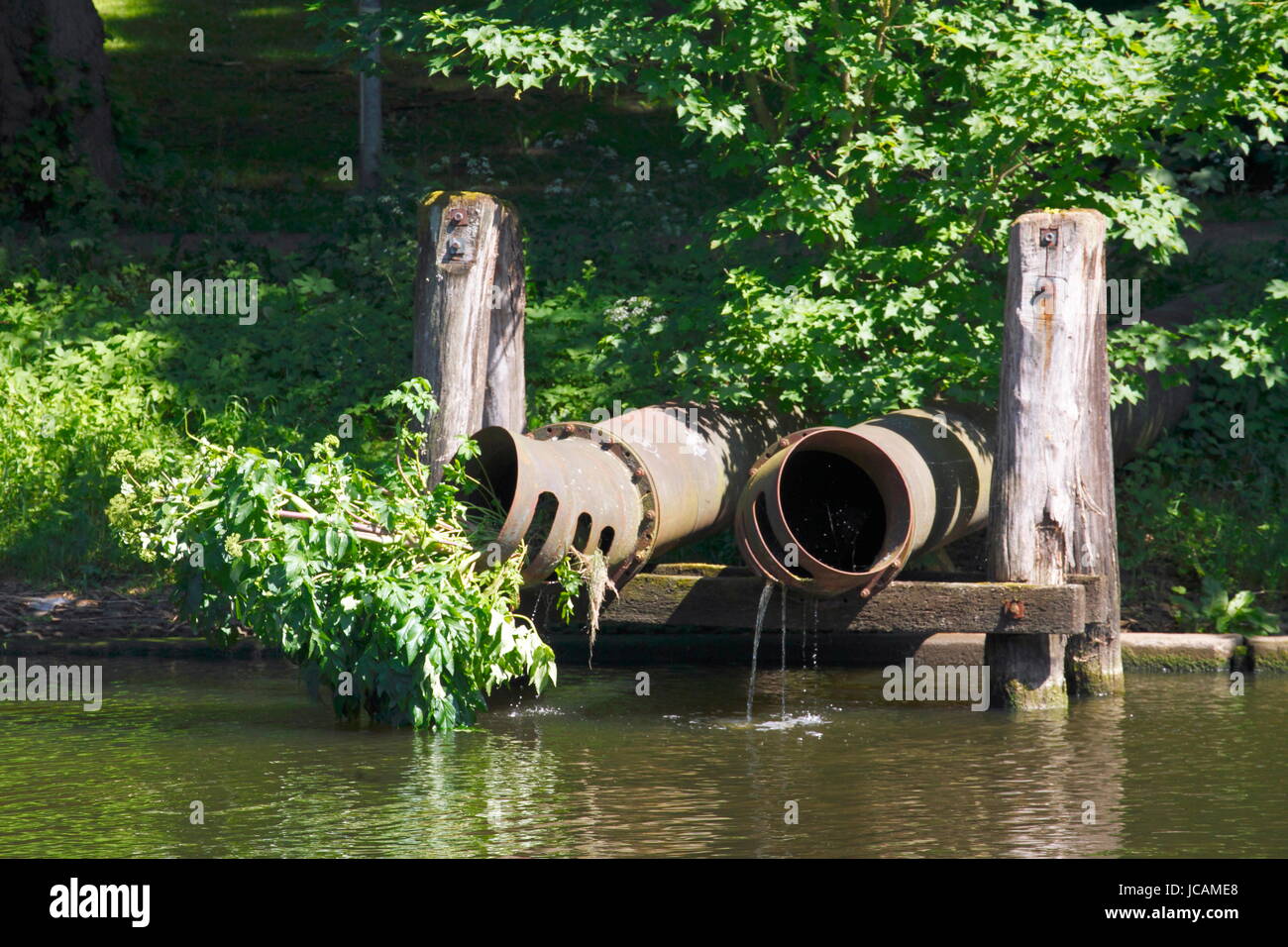 old canal pipes on River Stock Photo - Alamy