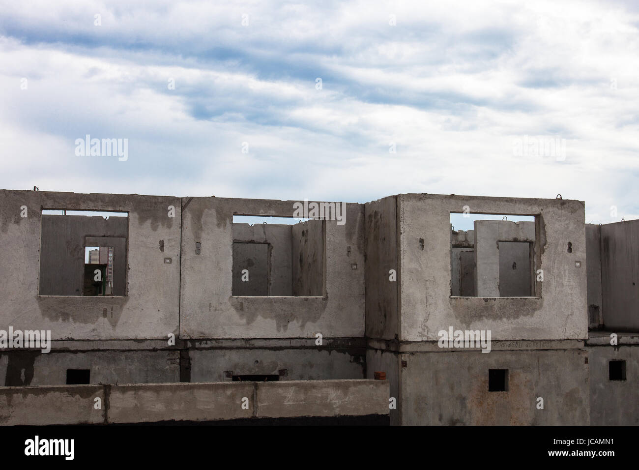 Unfinished grey concrete building in the construction site Stock Photo ...