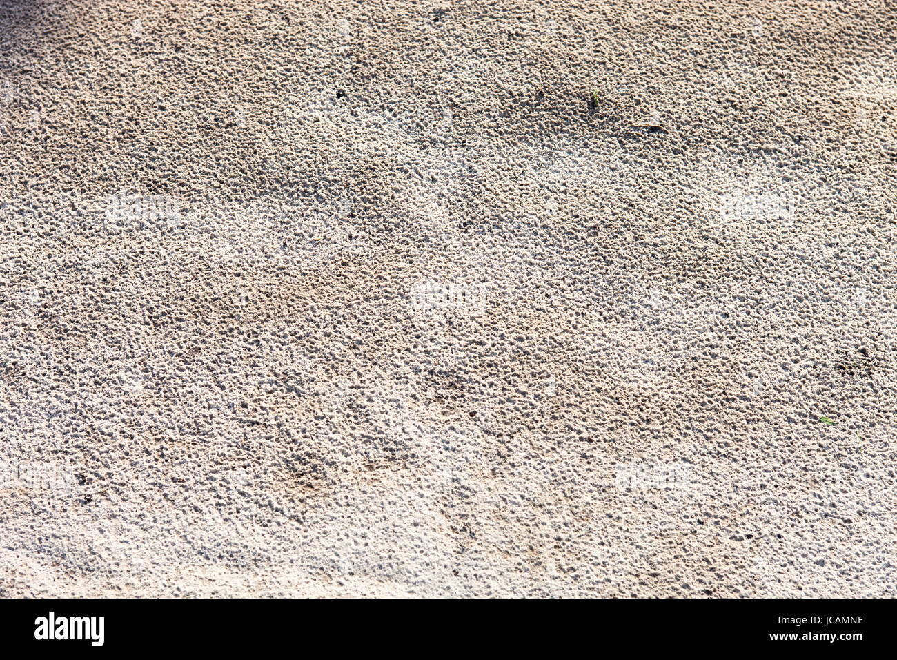 Sand surface after the rain with the visible traces of the raindrops ...