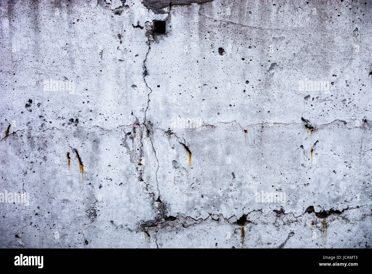 Grey concrete surface with the hardened traces of the shuttering moulds ...