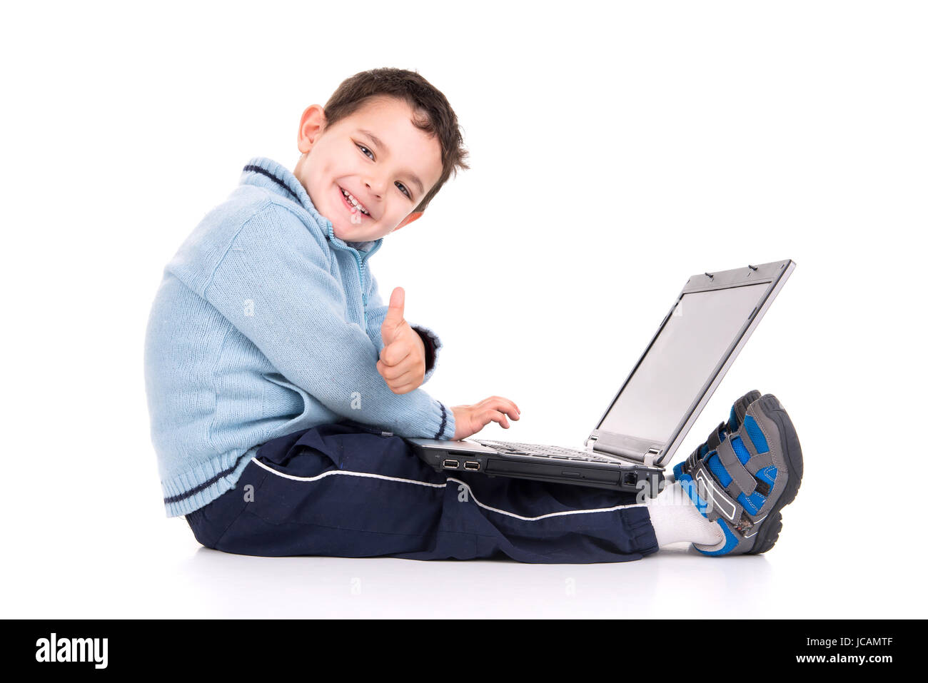 Young boy with laptop computer isolated in white Stock Photo - Alamy