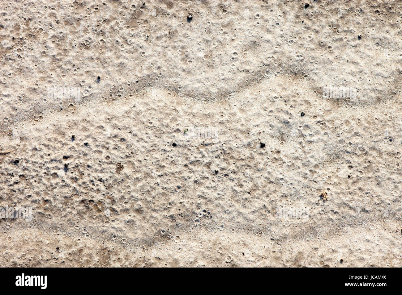 Sand surface after the rain with the visible traces of the raindrops ...
