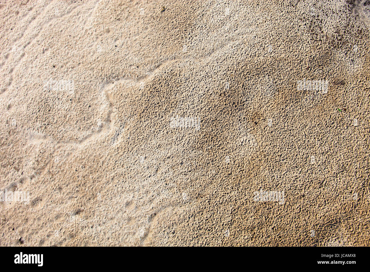 Sand surface after the rain with the visible traces of the raindrops ...