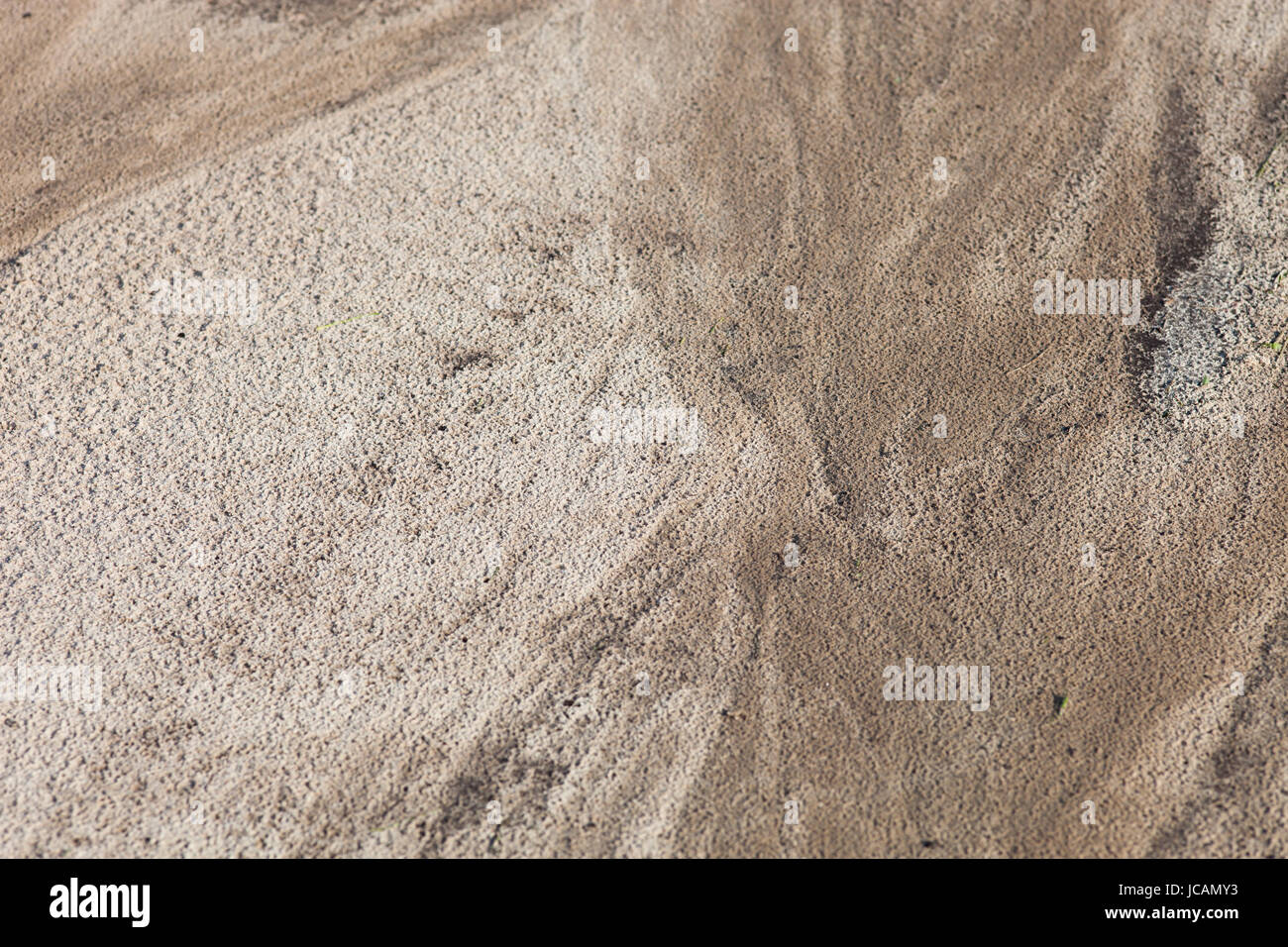 Sand surface after the rain with the visible traces of the raindrops ...