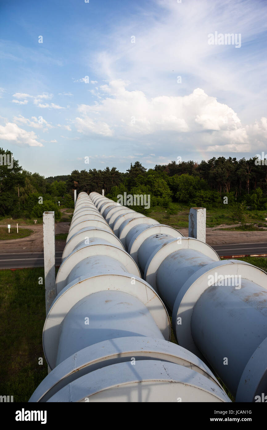 Elevated section of the pipelines above the road Stock Photo - Alamy