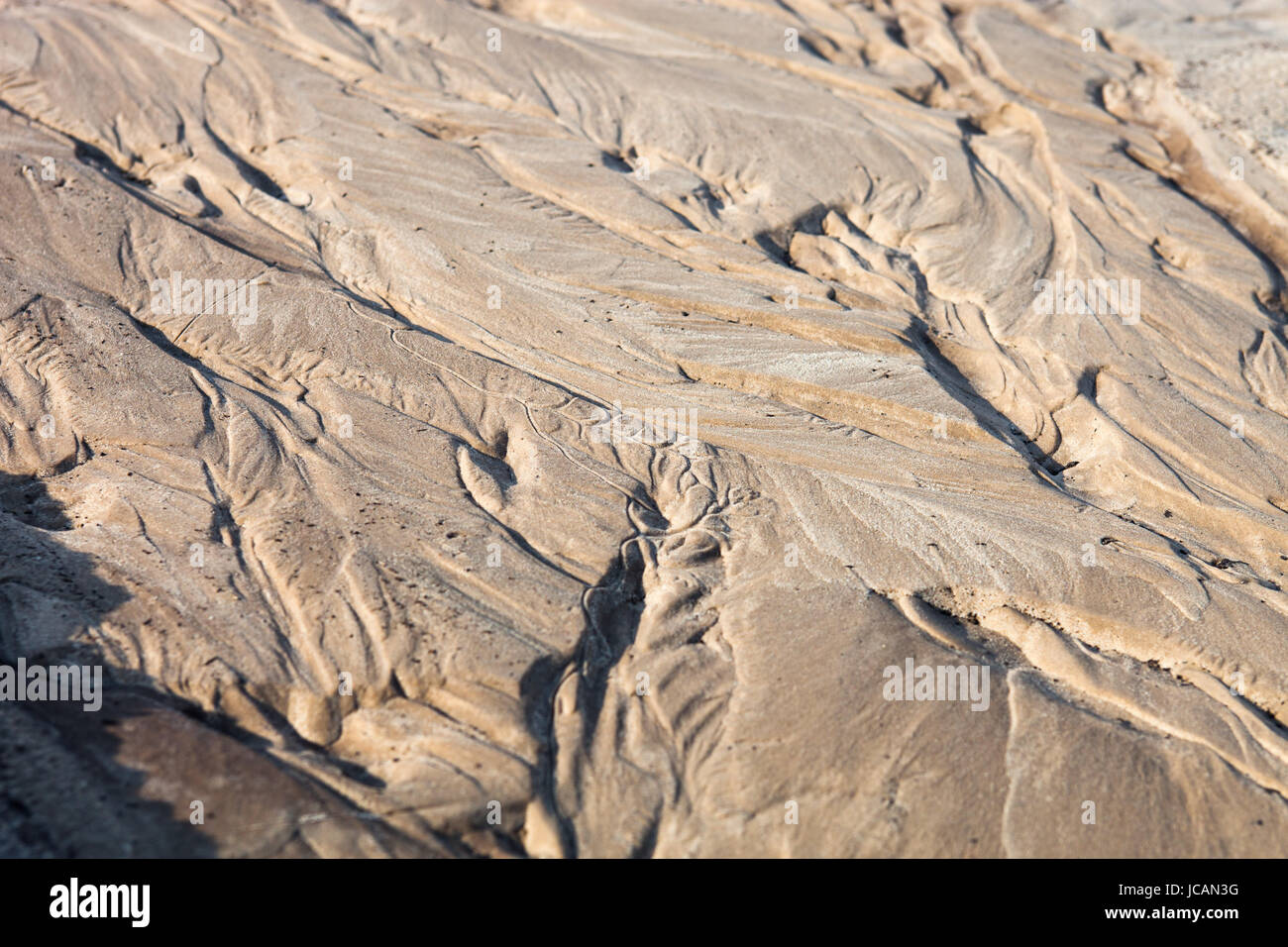 Sand surface after the rain with the relief formed by water currents ...