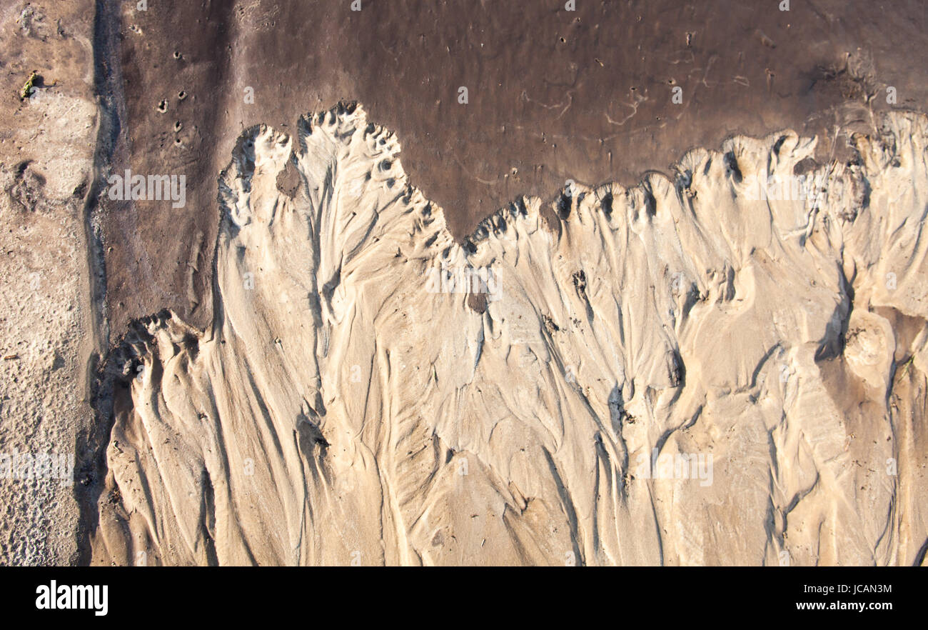 Sand surface after the rain with the relief formed by water currents ...