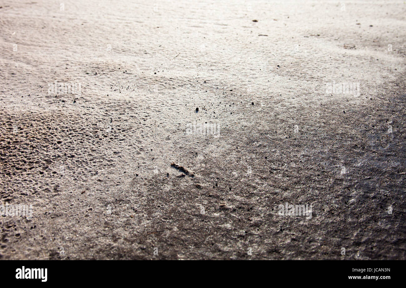 Sand surface after the rain with the visible traces of the raindrops ...
