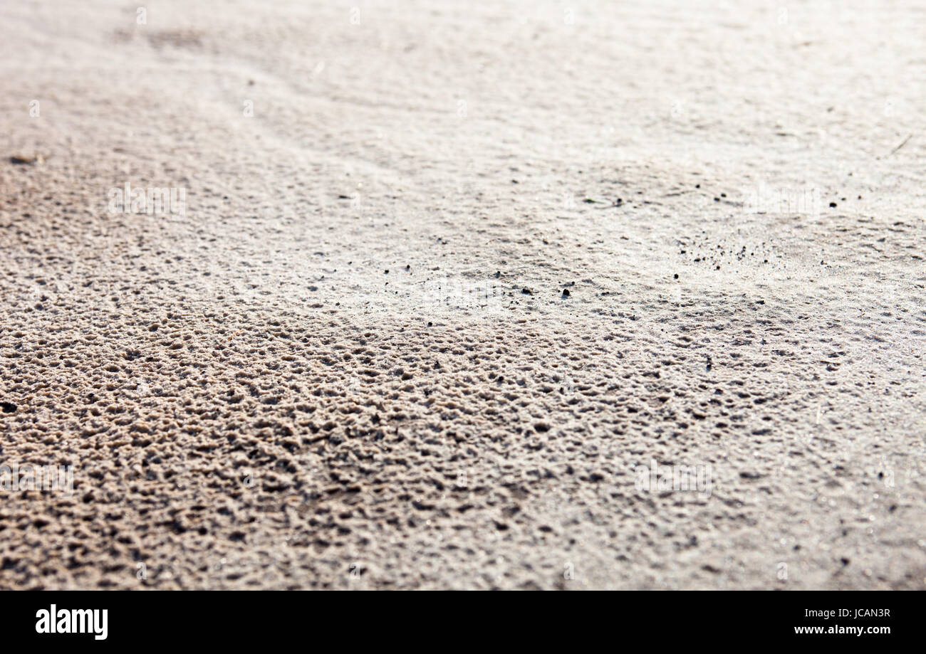Sand surface after the rain with the visible traces of the raindrops ...