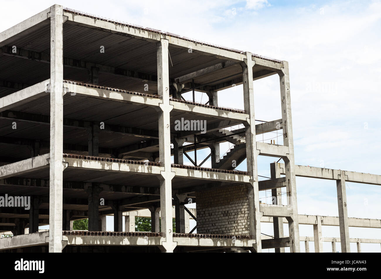 Unfinished grey concrete framework of the future building in the ...