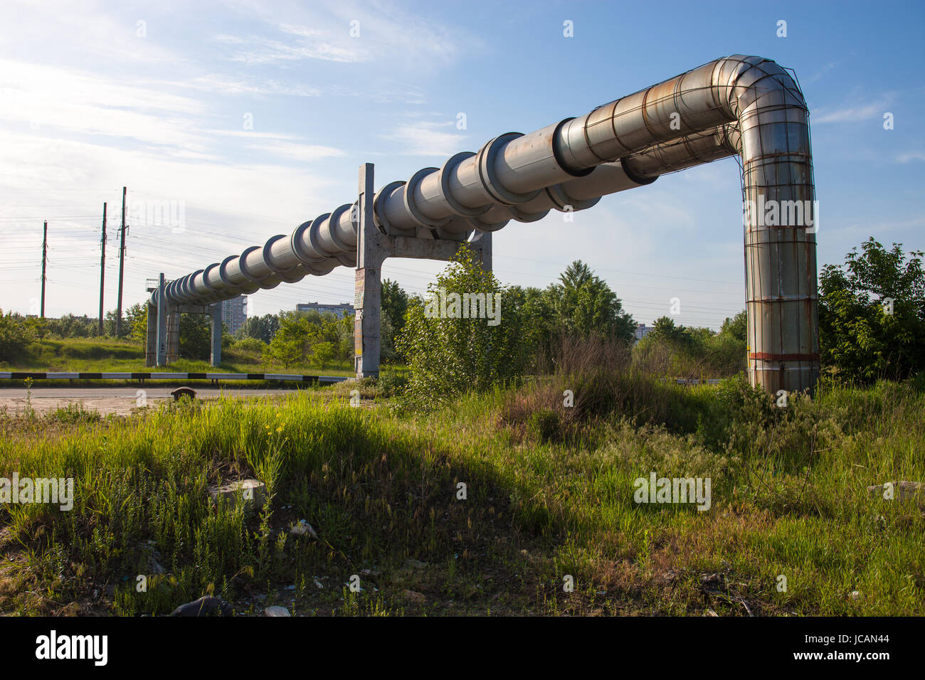 Elevated section of the pipelines above the road Stock Photo - Alamy