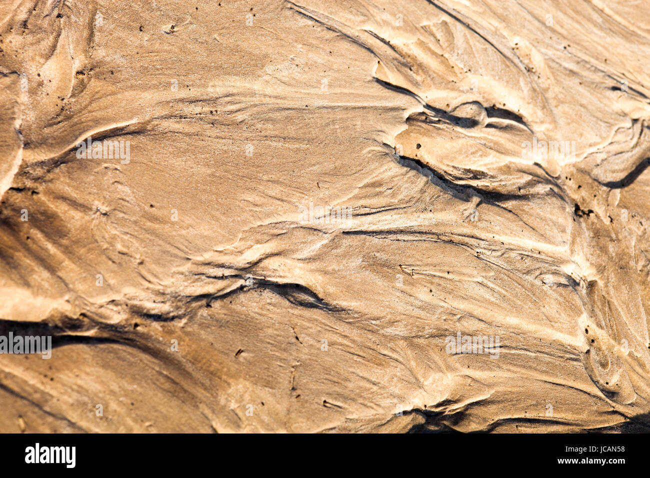 Sand surface after the rain with the relief formed by water currents ...
