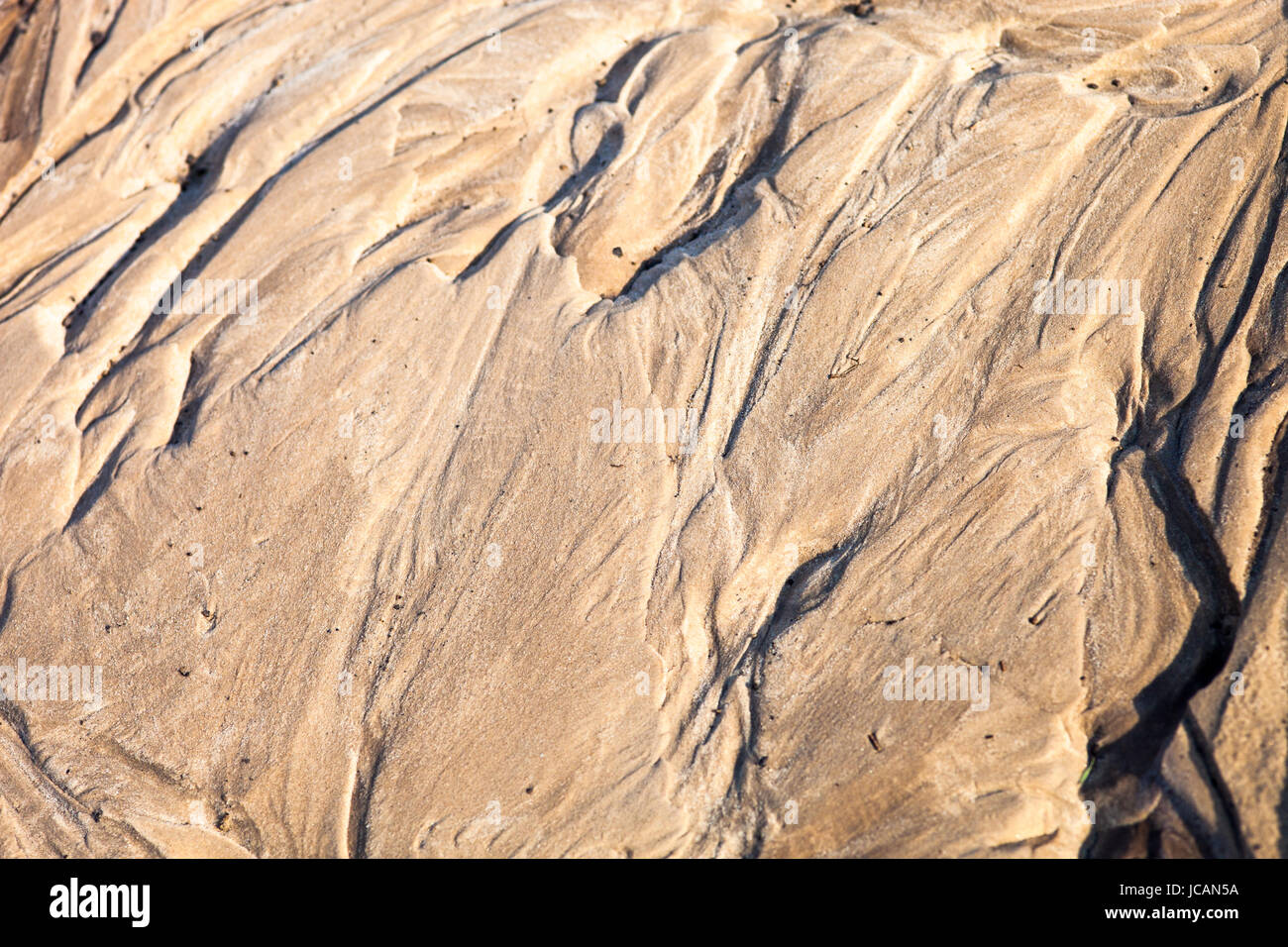 Sand surface after the rain with the relief formed by water currents ...
