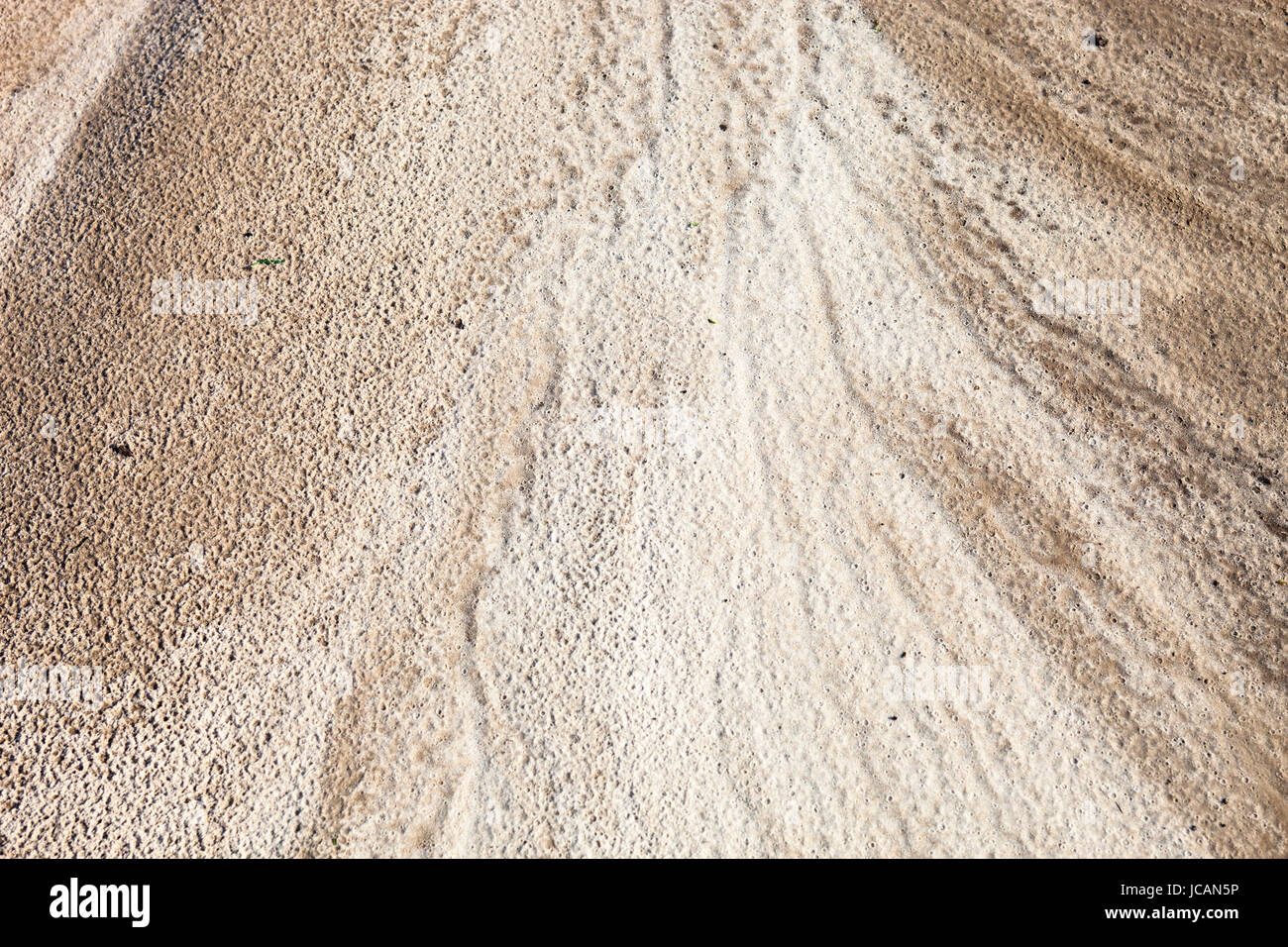 Sand surface after the rain with the visible traces of the raindrops ...