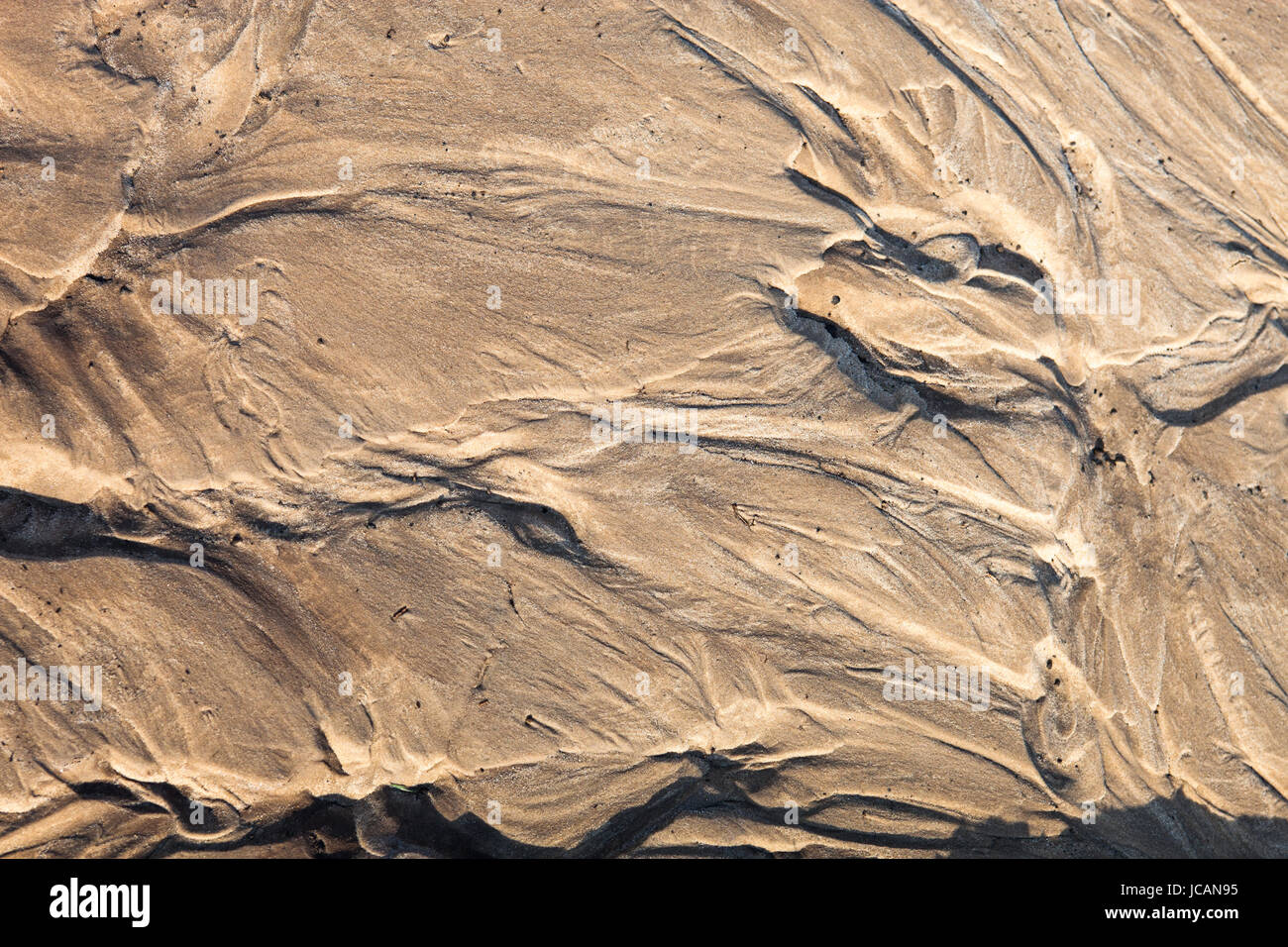 Sand surface after the rain with the relief formed by water currents ...
