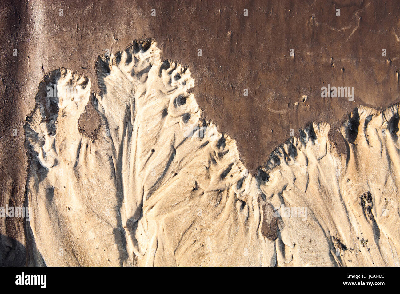 Sand surface after the rain with the relief formed by water currents ...