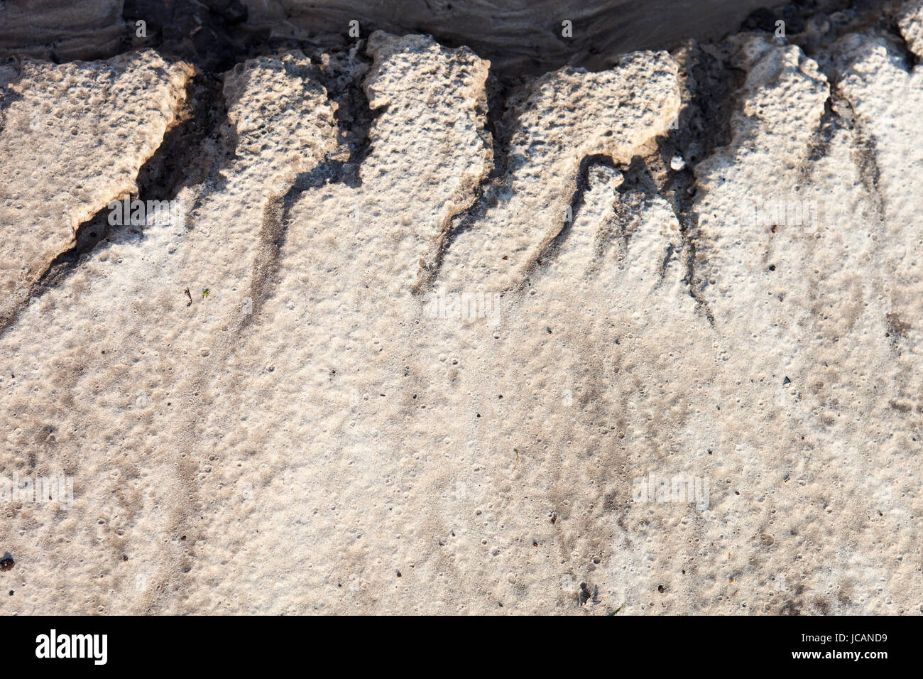 Sand surface after the rain with the relief formed by water currents ...