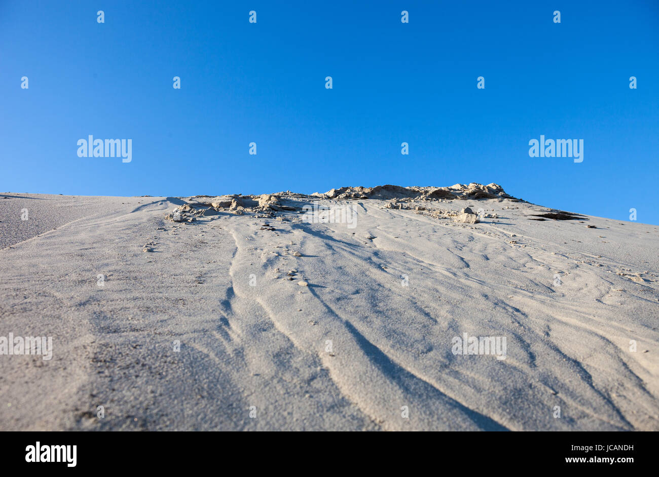 Gray sand dunes and the blue sky Stock Photo - Alamy