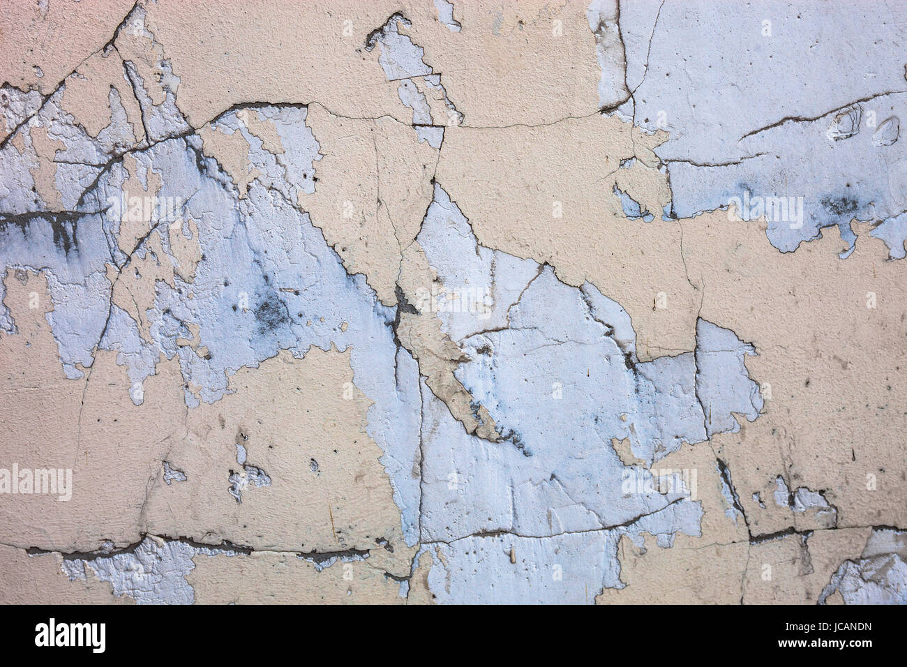 Cracked concrete surface with the remains of sandy-tan paint Stock ...