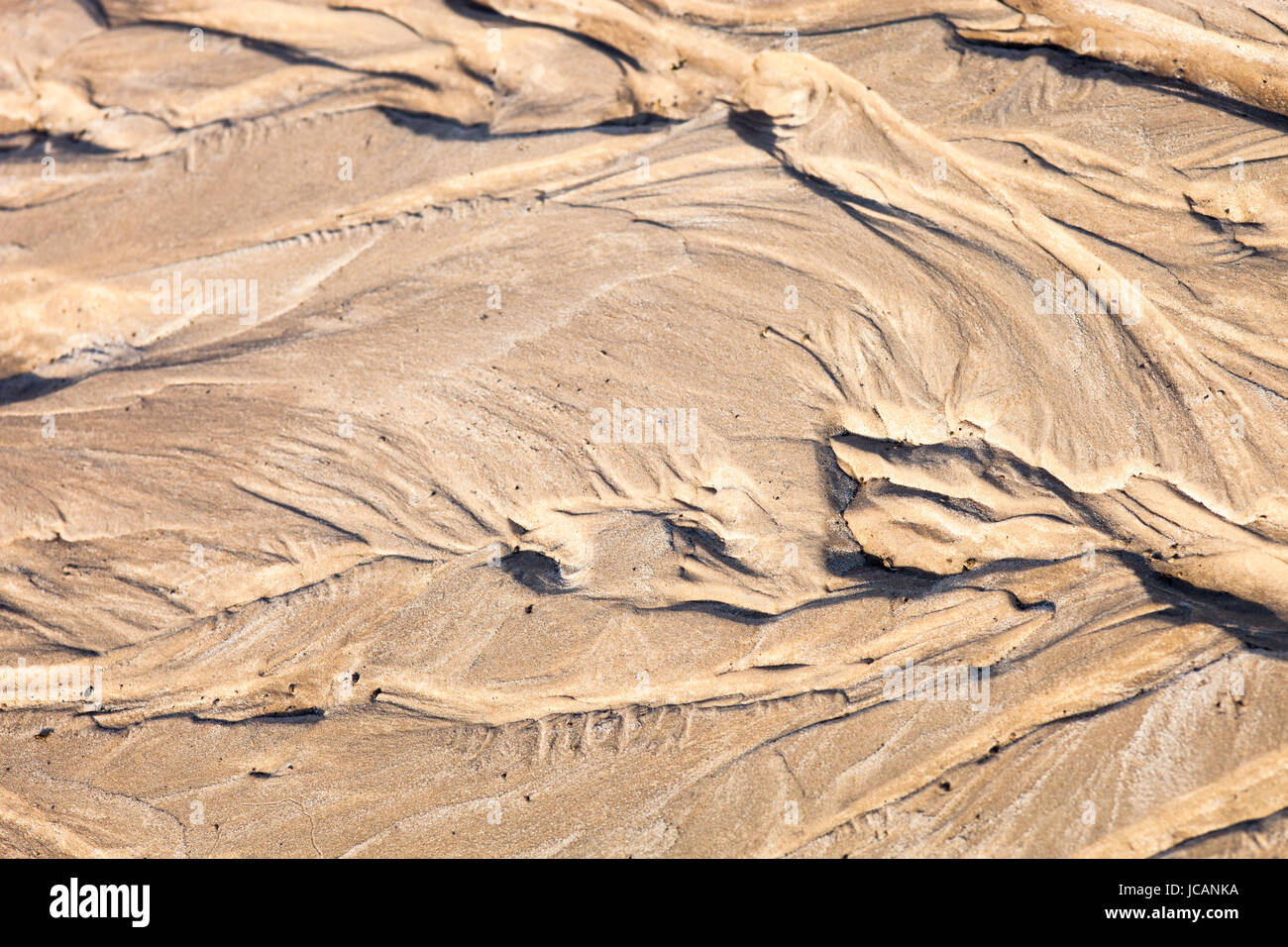 Sand surface after the rain with the relief formed by water currents ...