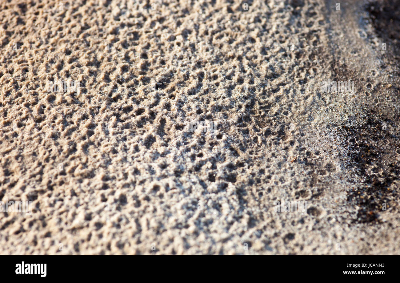 Sand surface after the rain with the visible traces of the raindrops ...