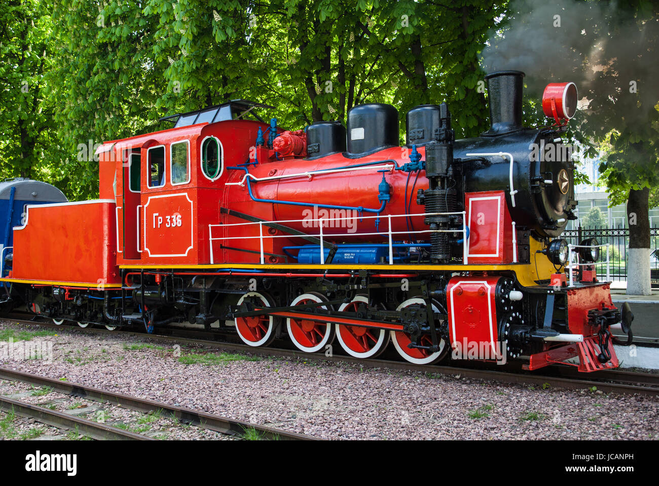 Steam locomotive with the smoke blowing off out of the smokestack Stock ...