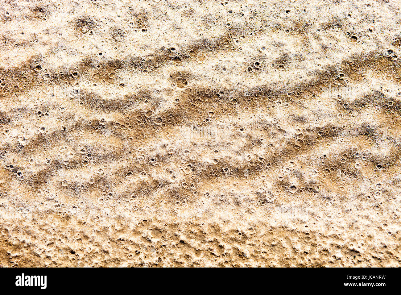 Sand surface after the rain with the visible traces of the raindrops ...