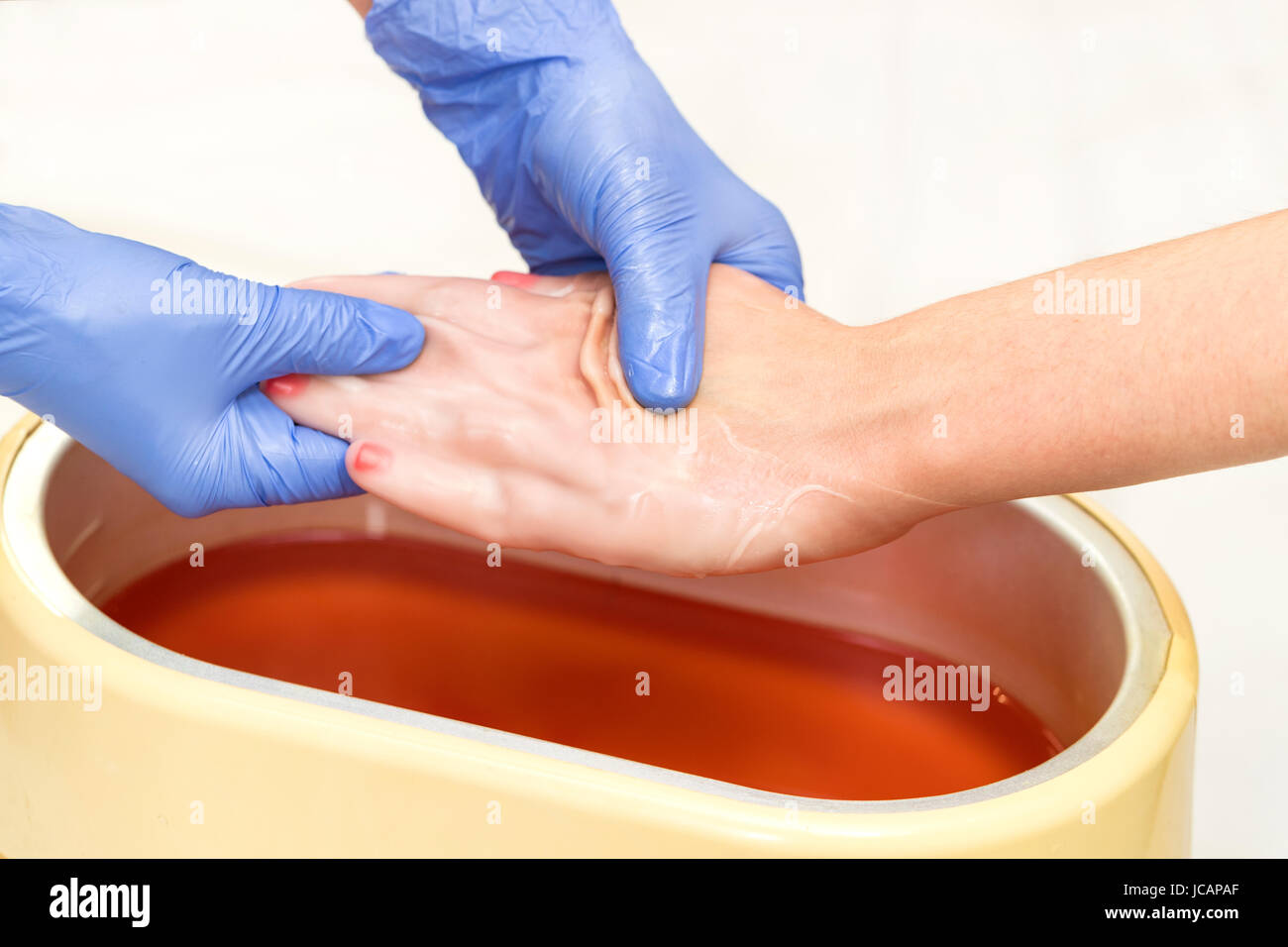 Process paraffin treatment of female hands in beauty salon Stock Photo ...