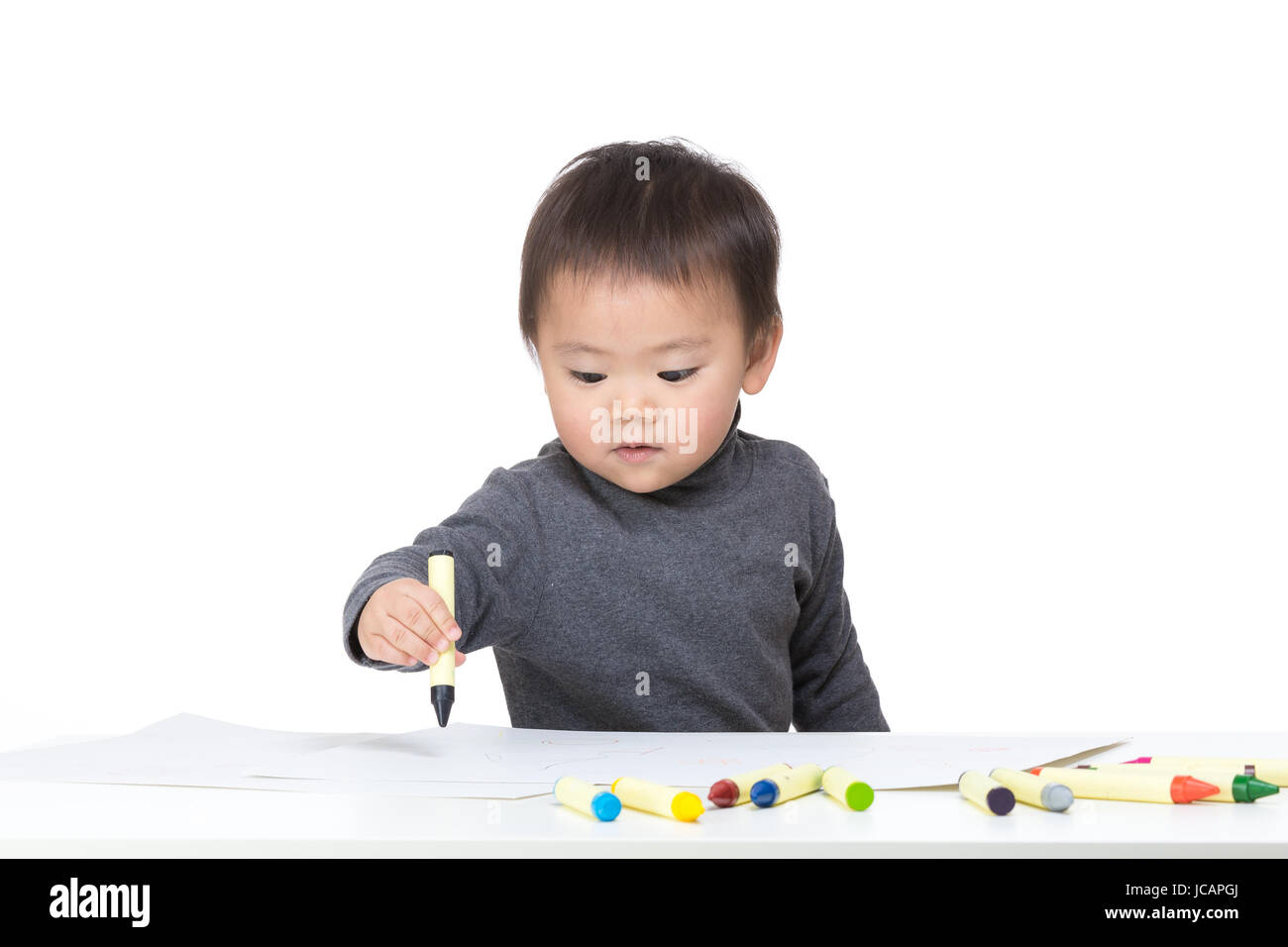Asian baby boy concentrate on drawing Stock Photo - Alamy