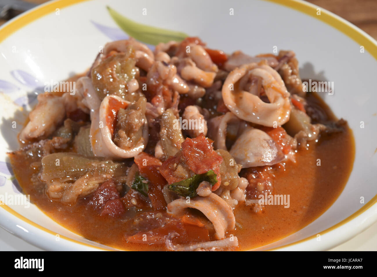 a typical italian recipe: soup of squid with tomato sauce Stock Photo ...