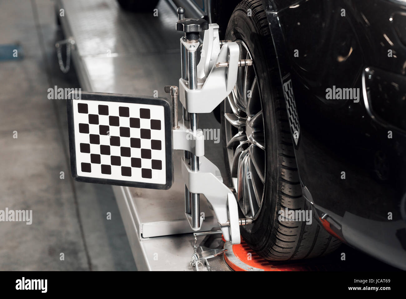Car on stand with sensors wheels for alignment camber check in workshop ...