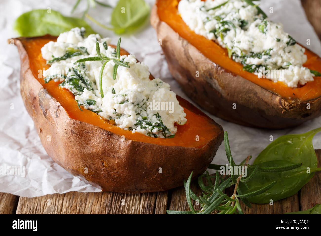 Baked yam filling with spinach and cream cheese close-up on the table ...