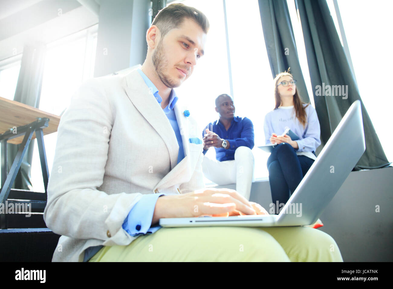 Male business executive using laptop in office Stock Photo - Alamy