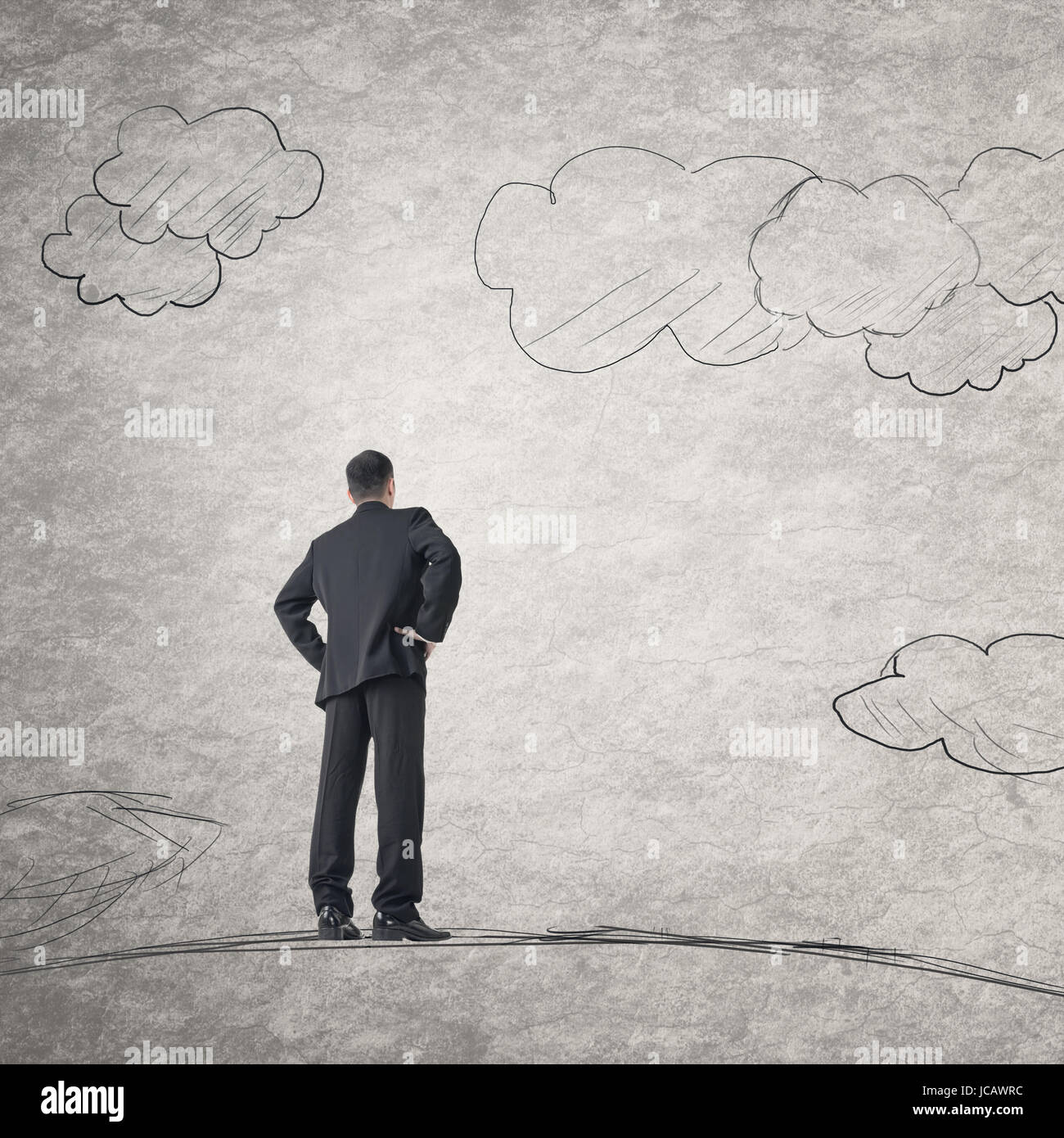 Confident businessman standing and looking into distance, low angle ...