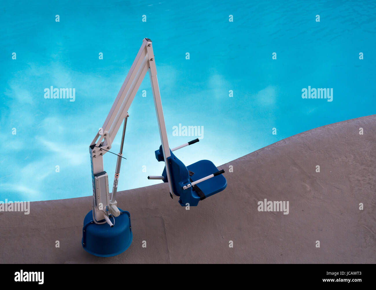 Disabled person poolside lift by swimming pool Stock Photo - Alamy