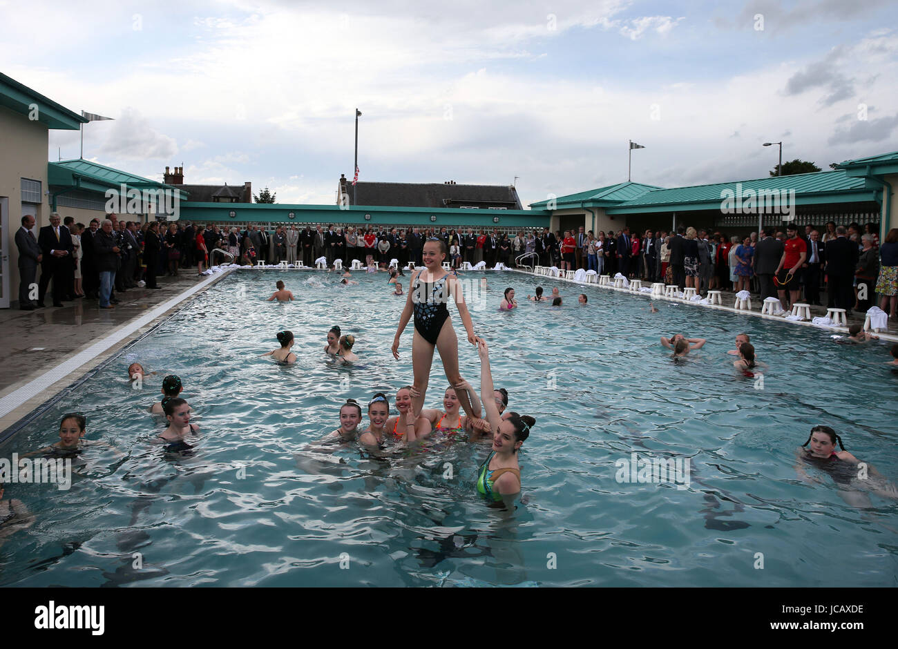 Swimmers perform a routine as The Prince of Wales, known as the Duke of ...