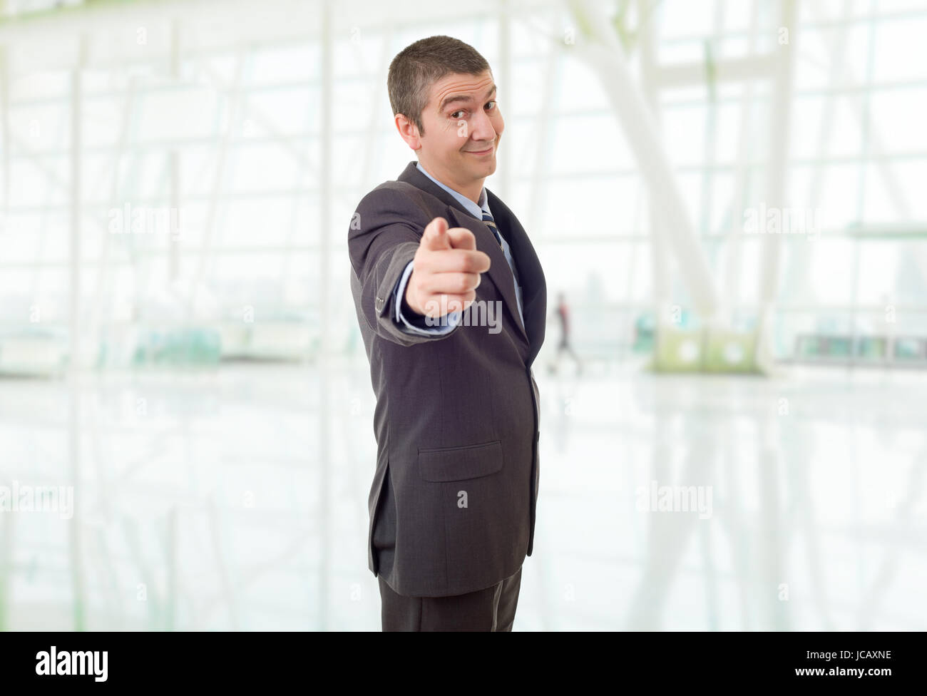 happy business man pointing, at the office Stock Photo - Alamy