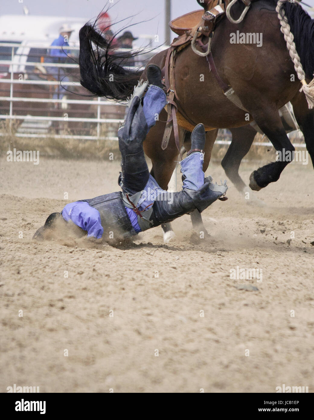 Saddle bronc rider falling off horse Stock Photo - Alamy