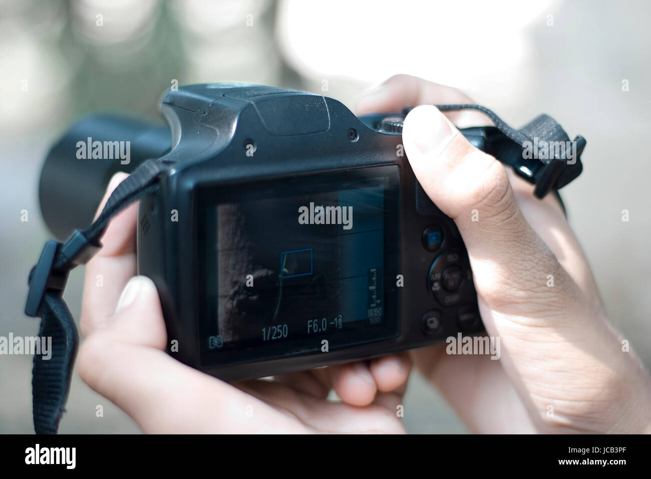 A man holding a digital camera Stock Photo - Alamy