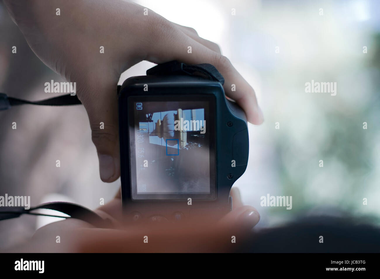 A youngster Boy holding digital camera Stock Photo - Alamy