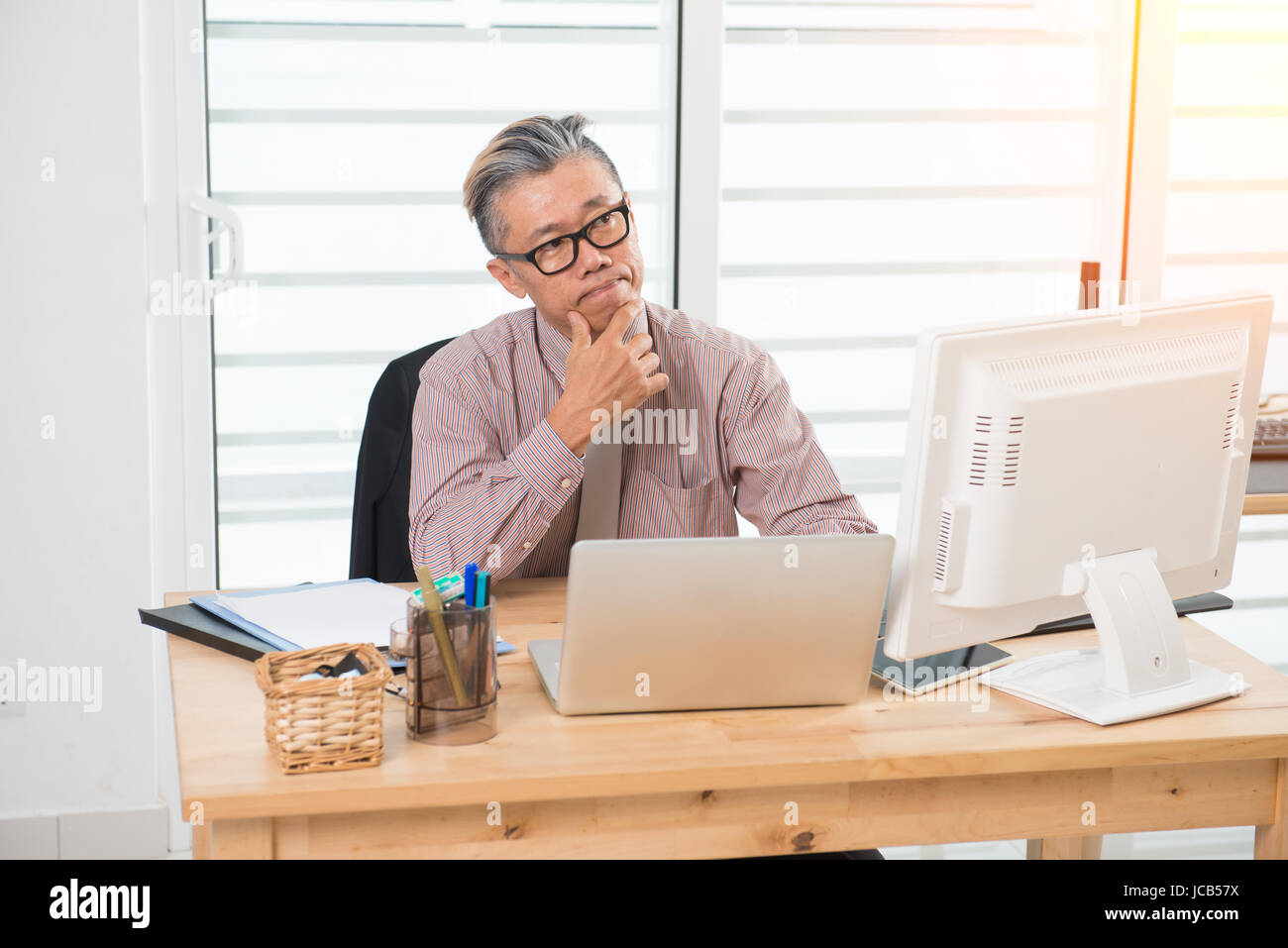 asian business senior male thinking Stock Photo - Alamy